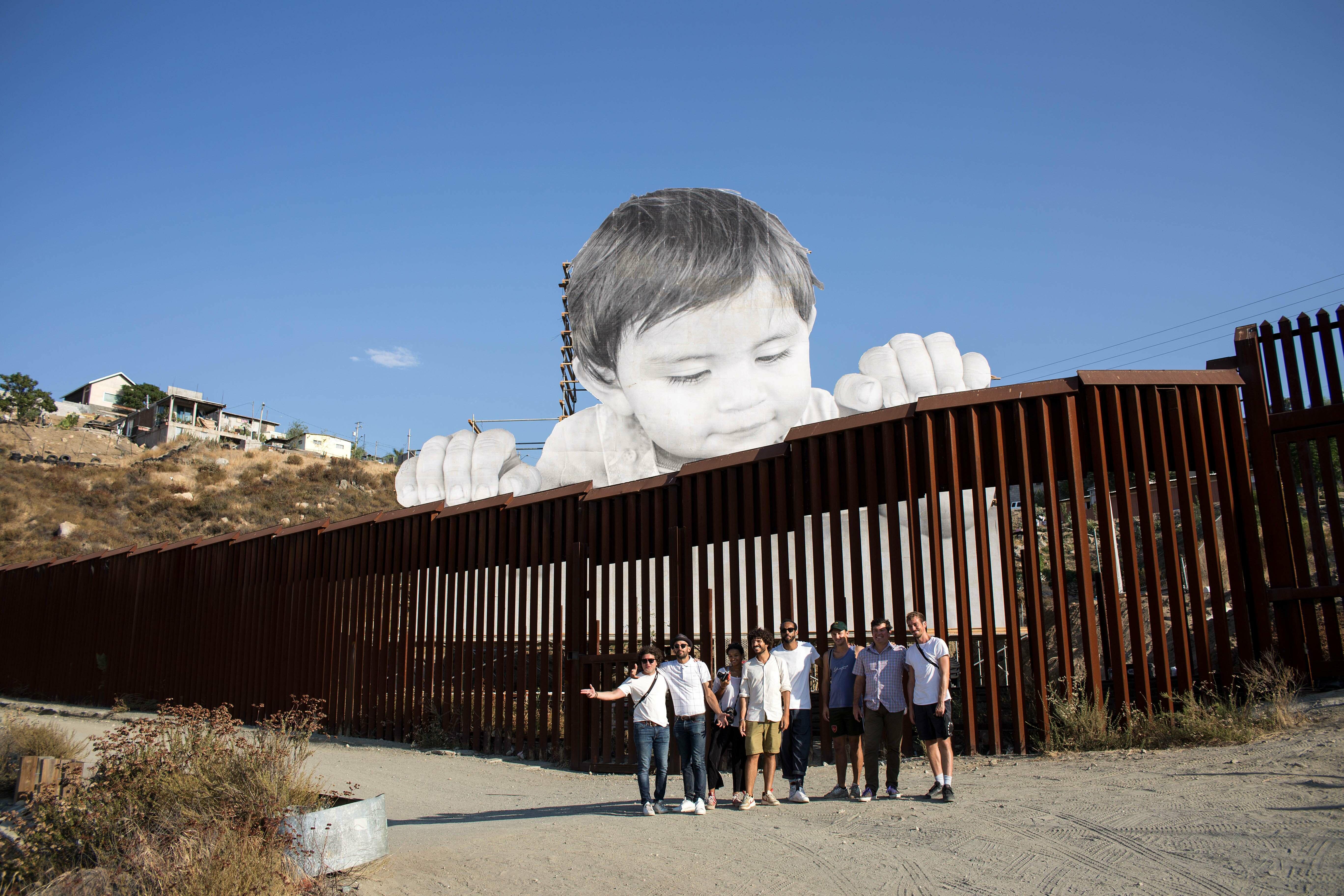 Yes, That's a Giant Toddler Peering Over Border Wall | iHeart